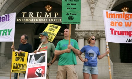 Demonstrators gather in front of the newly opened Trump International Hotel.